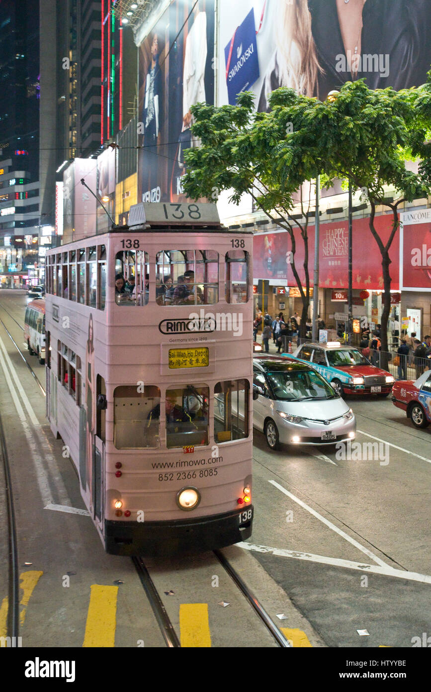 A tram crossing a busy intersection for pedestrians crossing the street ...