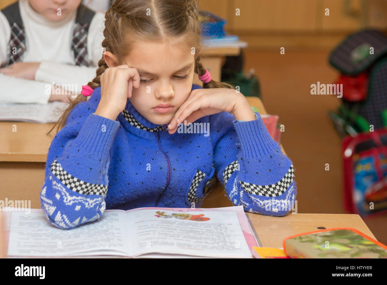 First grader girl feels bad in the classroom at school Stock Photo - Alamy