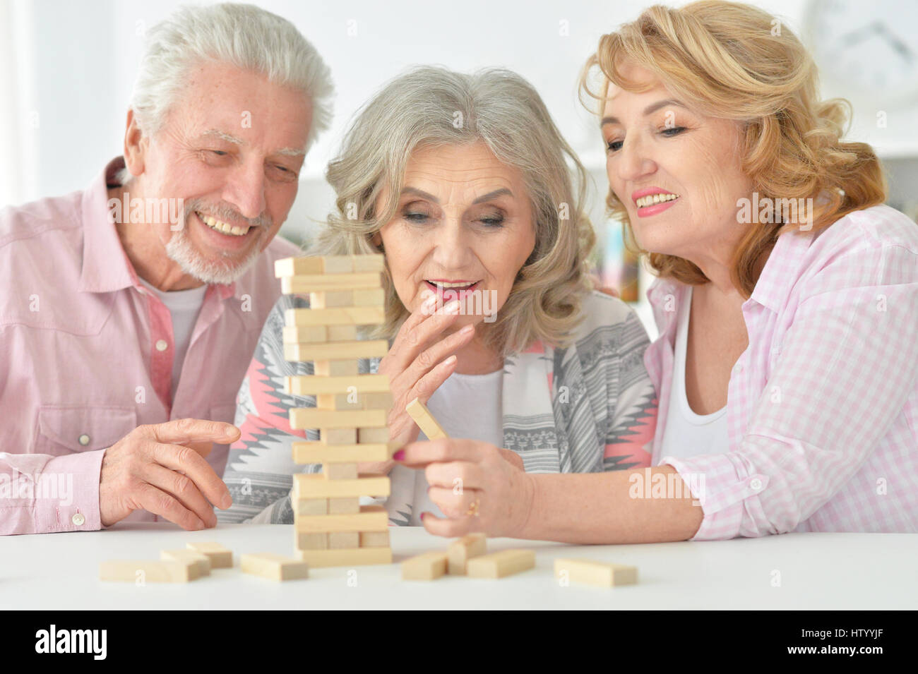Elderly people playing a board game Stock Photo - Alamy