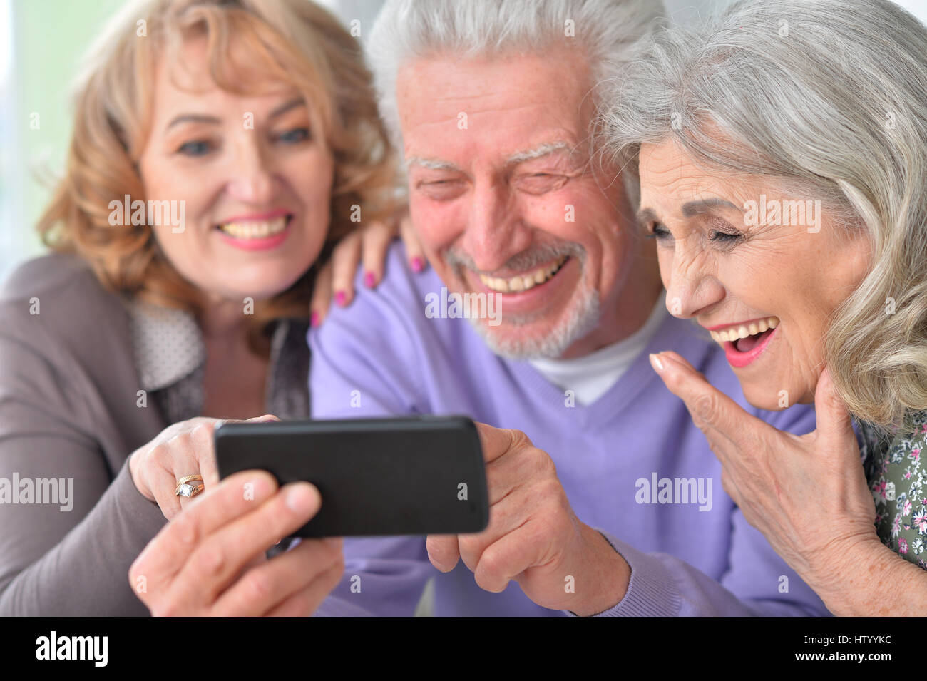 Elderly people using mobile phone Stock Photo - Alamy