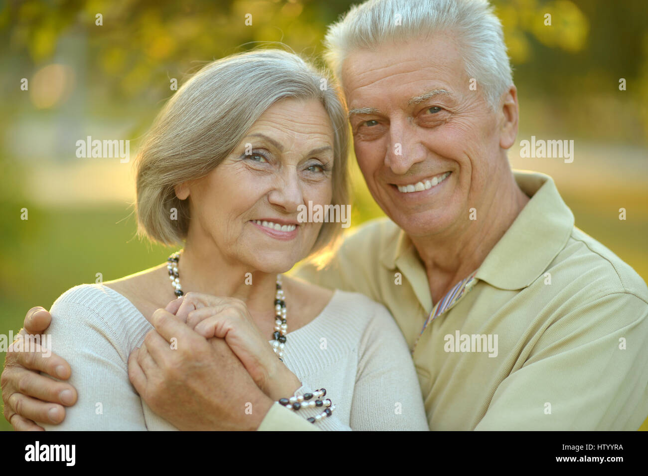 Happy elderly couple embracing Stock Photo - Alamy