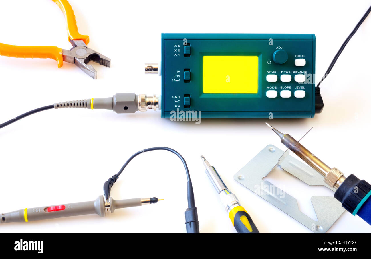 Modern digital signal oscilloscope and tools isolated on white ...