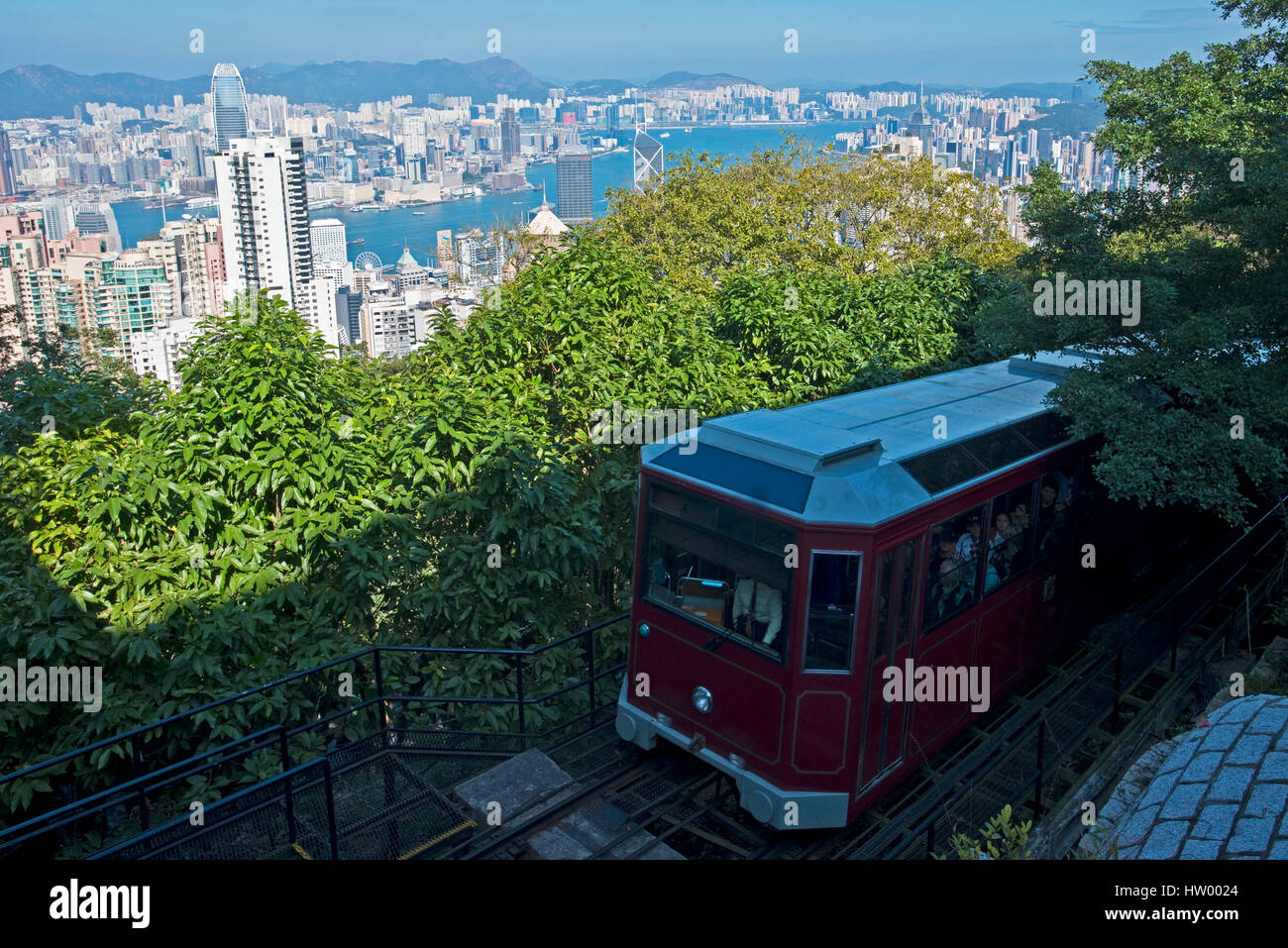 An aerial view over Hong Kong and Victoria Harbour with the Peak Tram a ...