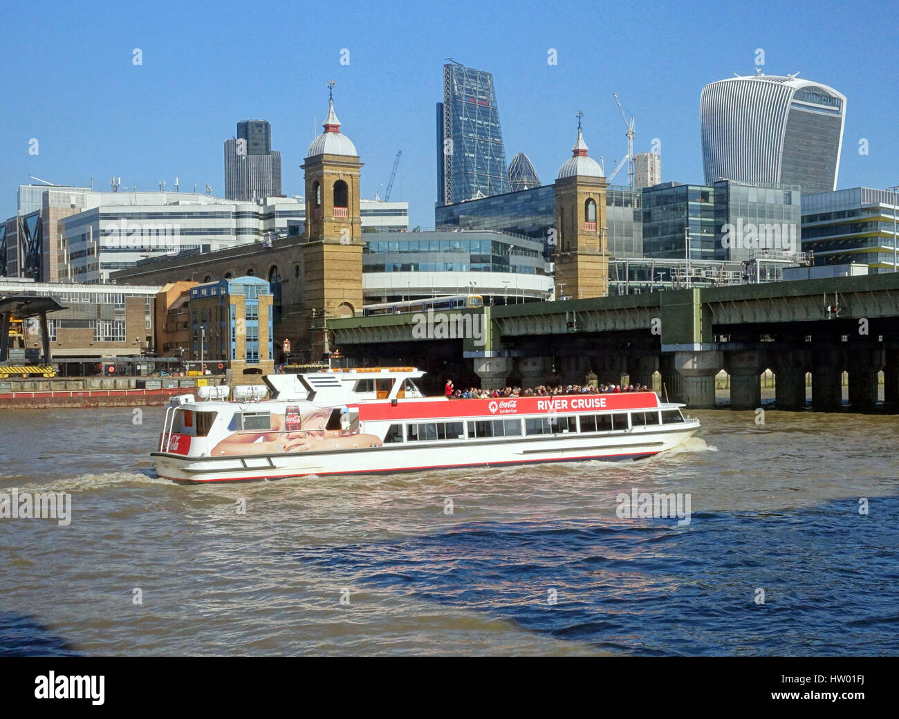 Pleasure cruiser on River Thames in front of City of London skyline ...