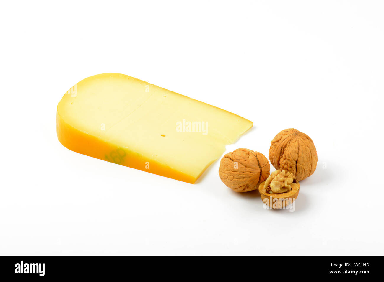 slice of gouda cheese with walnuts on white background Stock Photo - Alamy