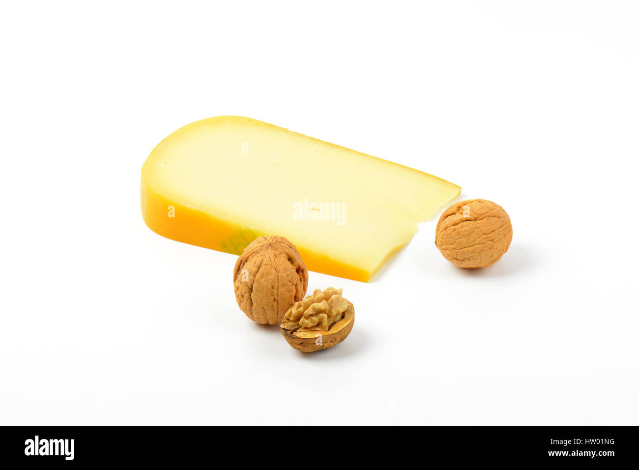 slice of gouda cheese with walnuts on white background Stock Photo - Alamy