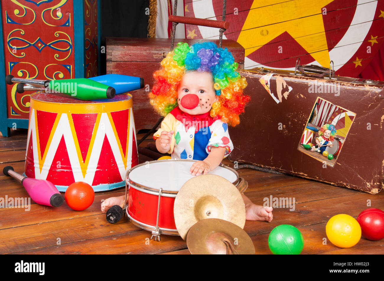 Little baby clown with red nose multi-colored wig in with balls Stock ...