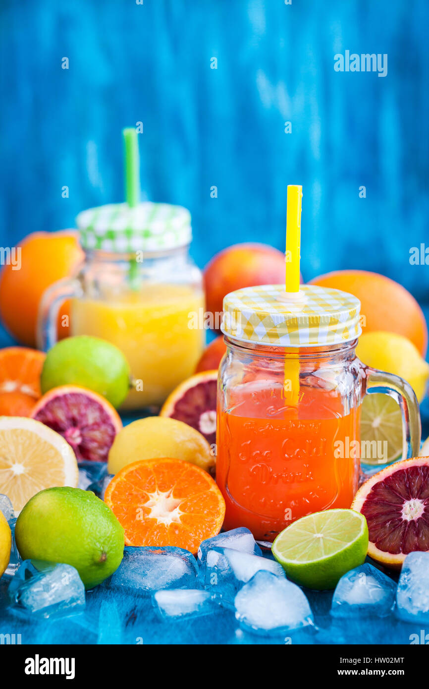 Citrus vitamin juice in mason jars with fresh oranges, mandarins ...