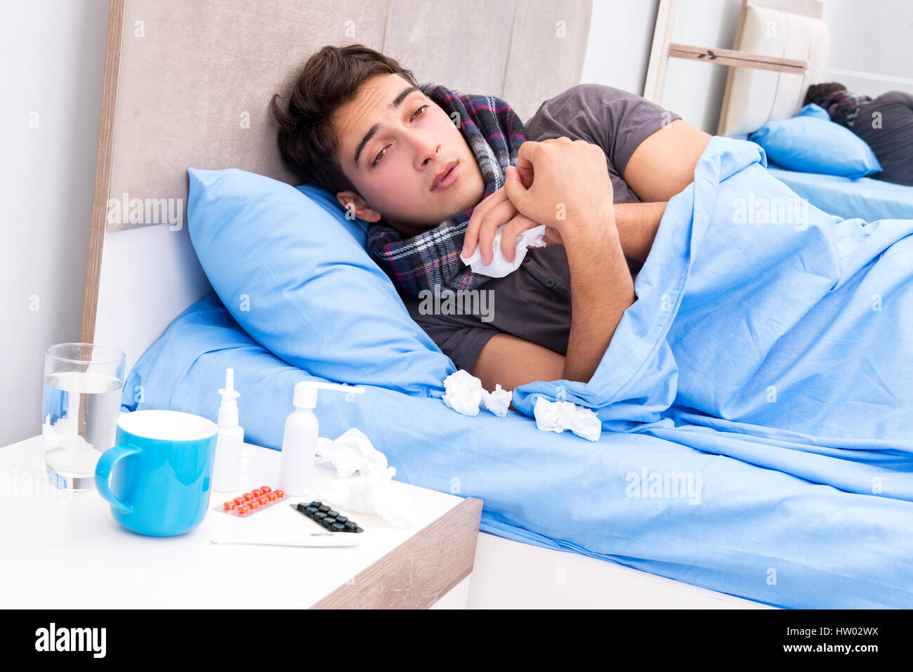 Sick man with flu lying in the bed Stock Photo - Alamy