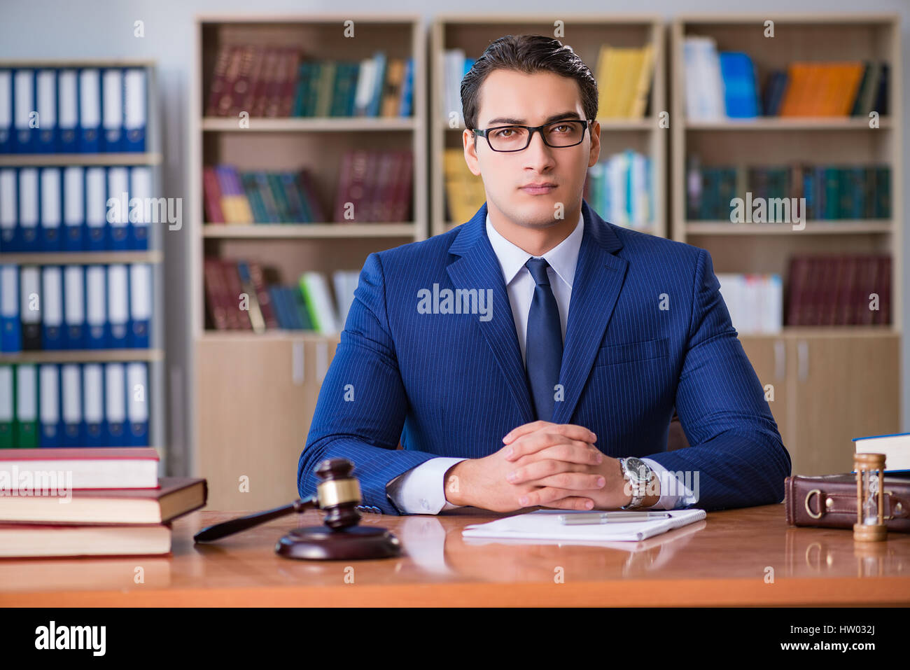Handsome judge with gavel sitting in courtroom Stock Photo - Alamy