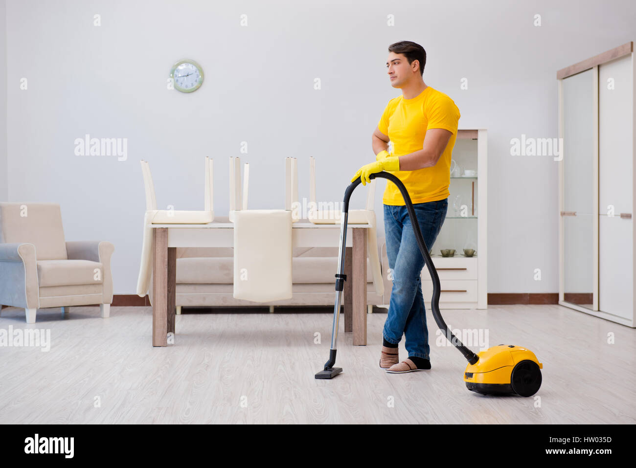 Man husband cleaning the house helping his wife Stock Photo - Alamy