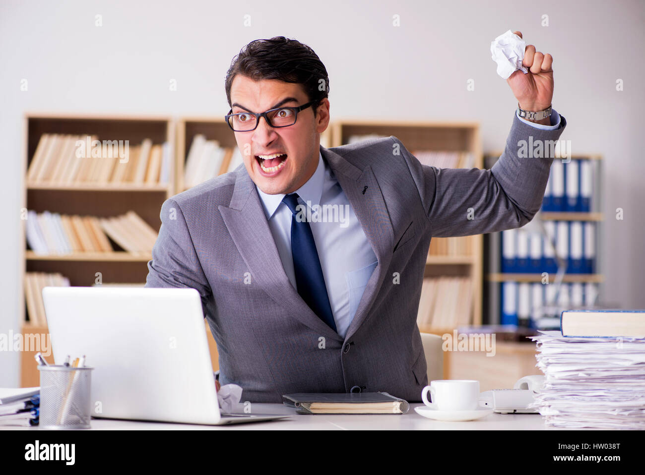 Angry businessman working in the office Stock Photo - Alamy