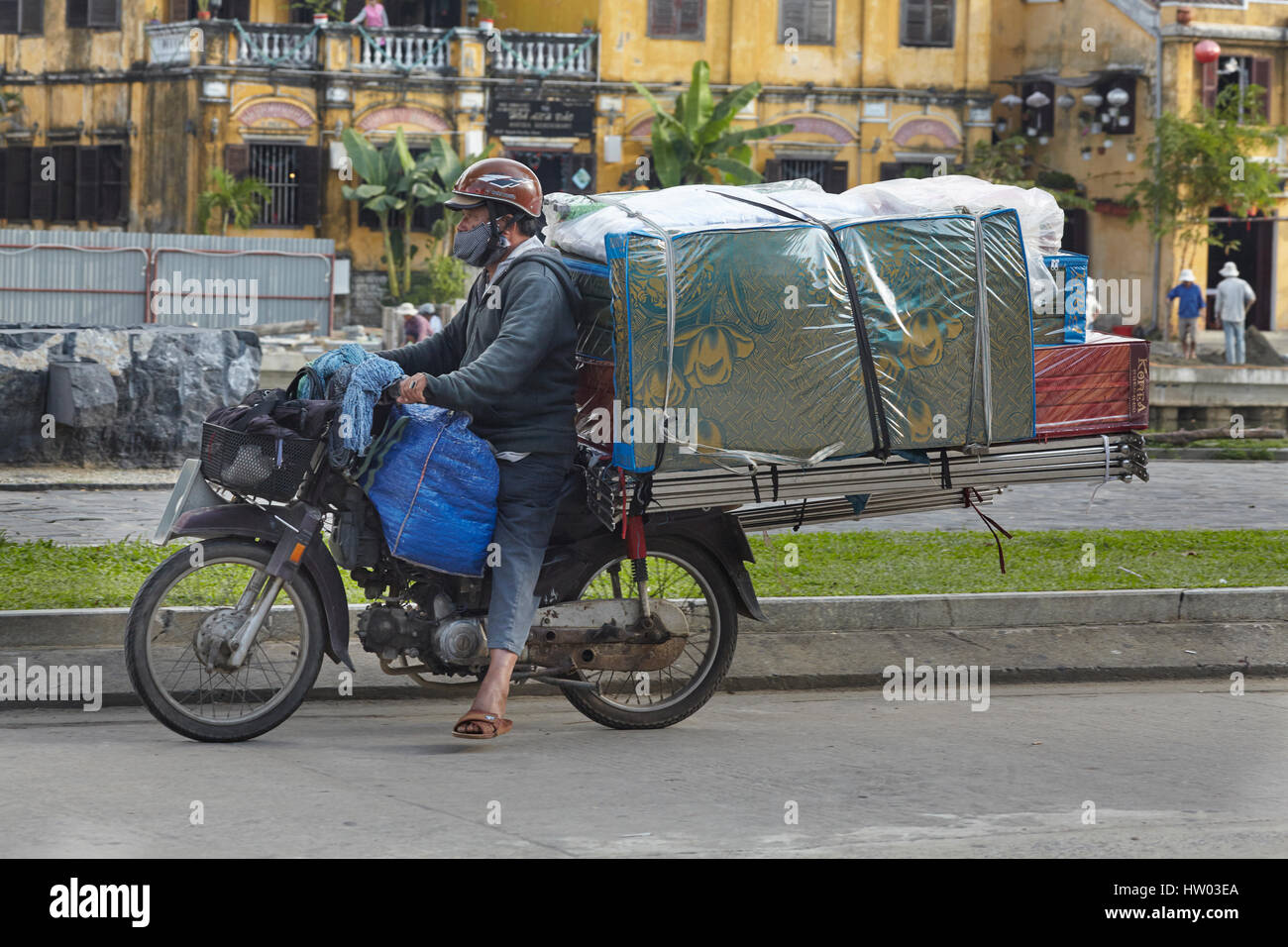 Overloaded motorcycle, Hoi An (UNESCO World Heritage Site), Vietnam ...