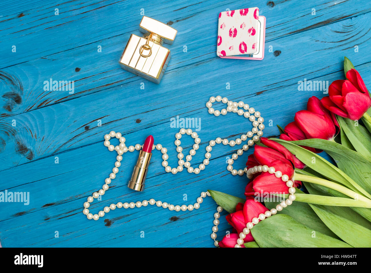 red tulips on a blue wooden board Stock Photo - Alamy