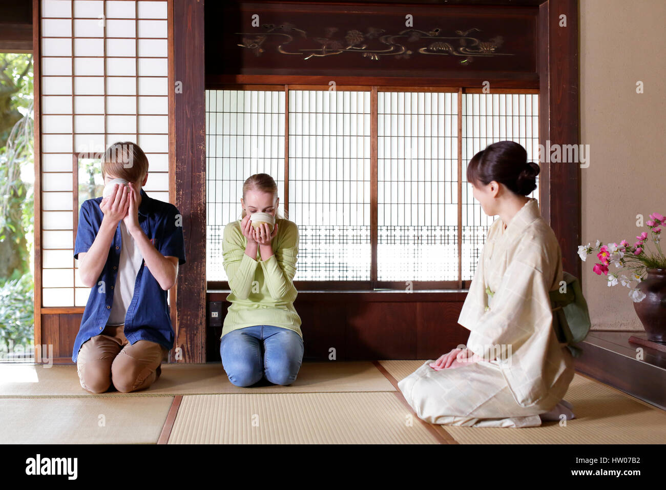 Caucasian couple enjoying tea ceremony at traditional Japanese house ...