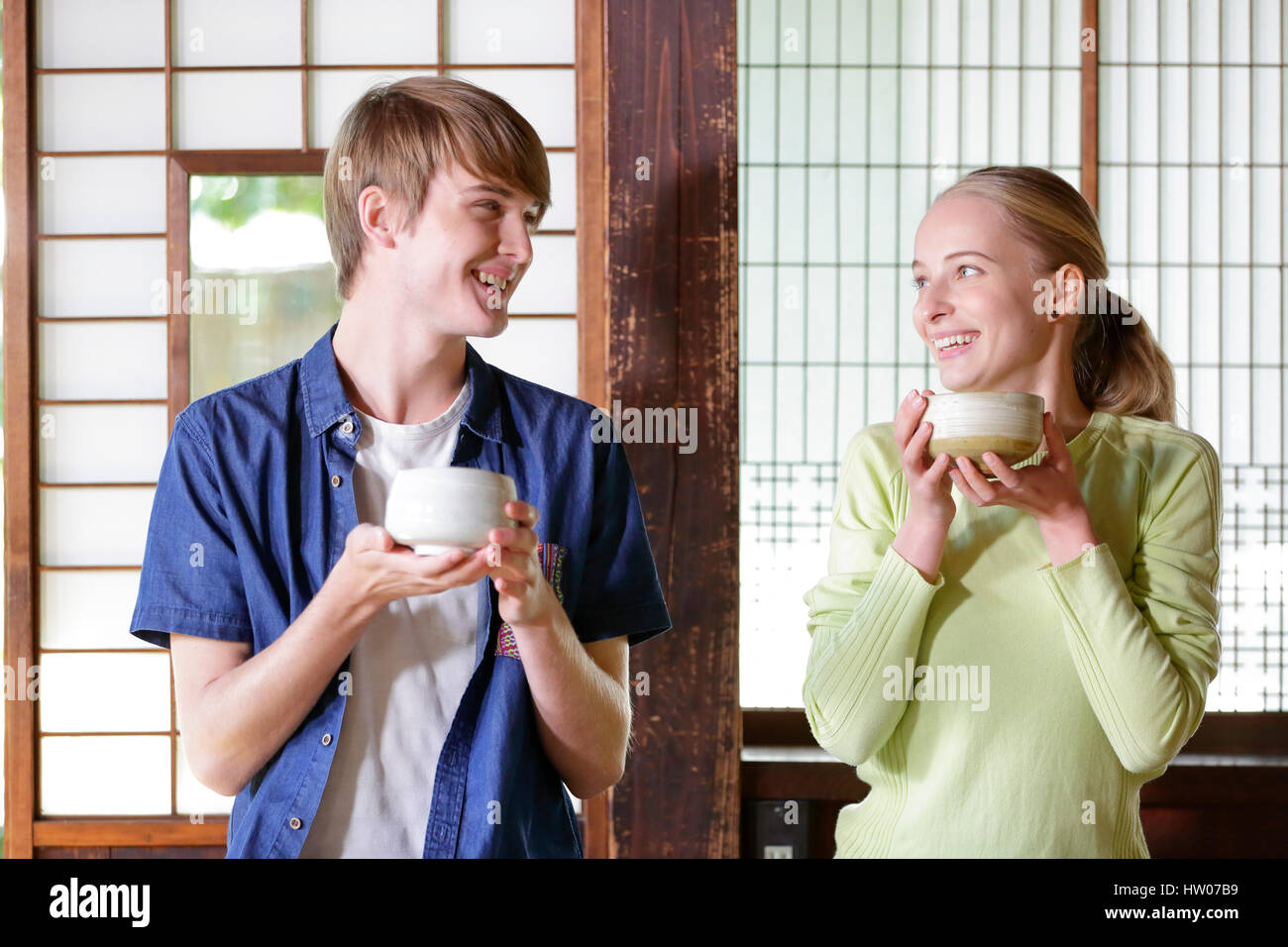 Caucasian couple enjoying tea ceremony at traditional Japanese house ...