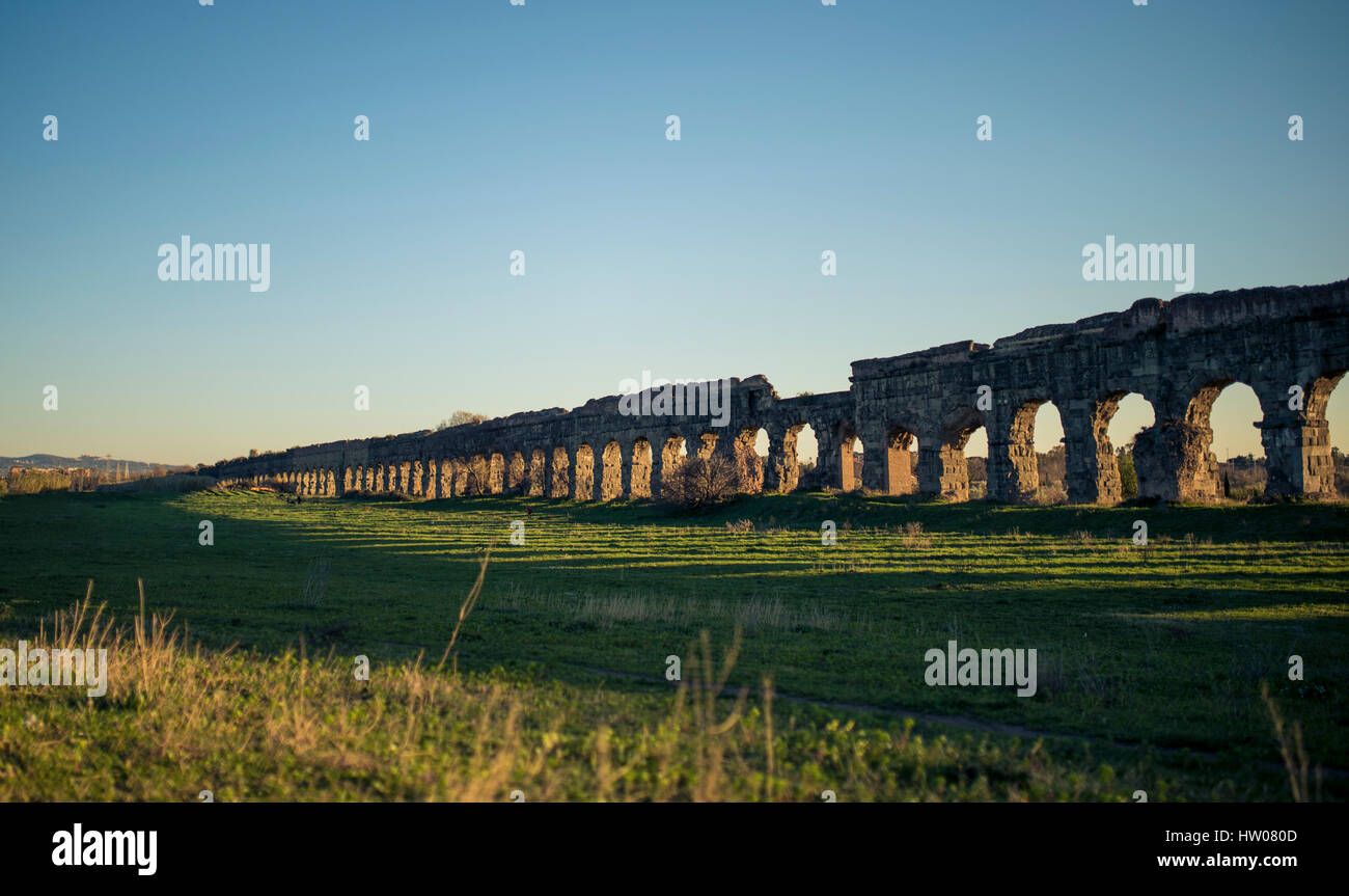Roman aqueduct ancient ruins in Italy at sunset Stock Photo - Alamy