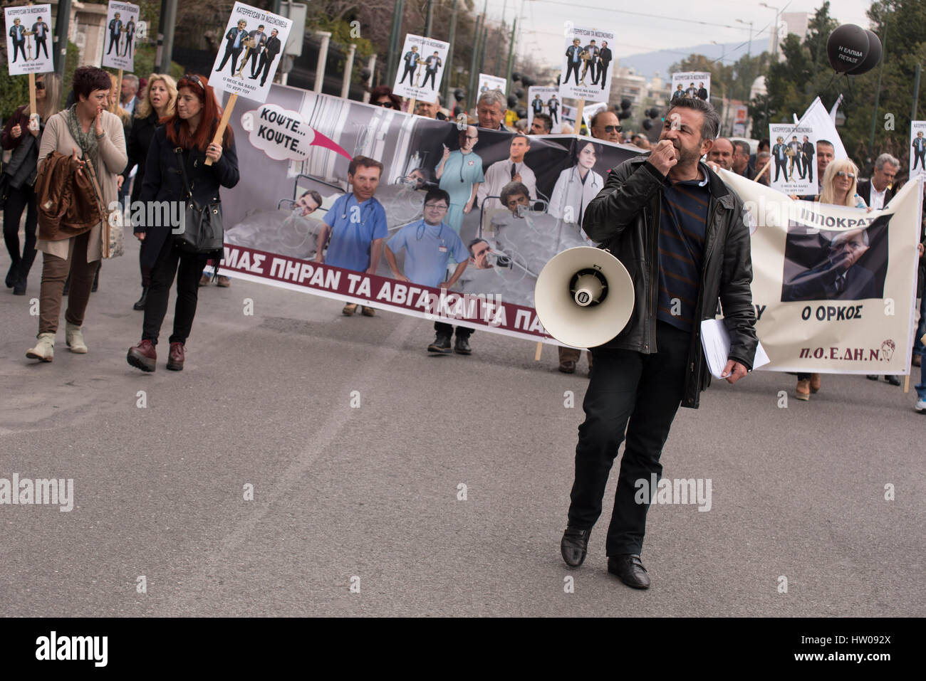 Public healthcare workers march shouting slogans and holding banners ...
