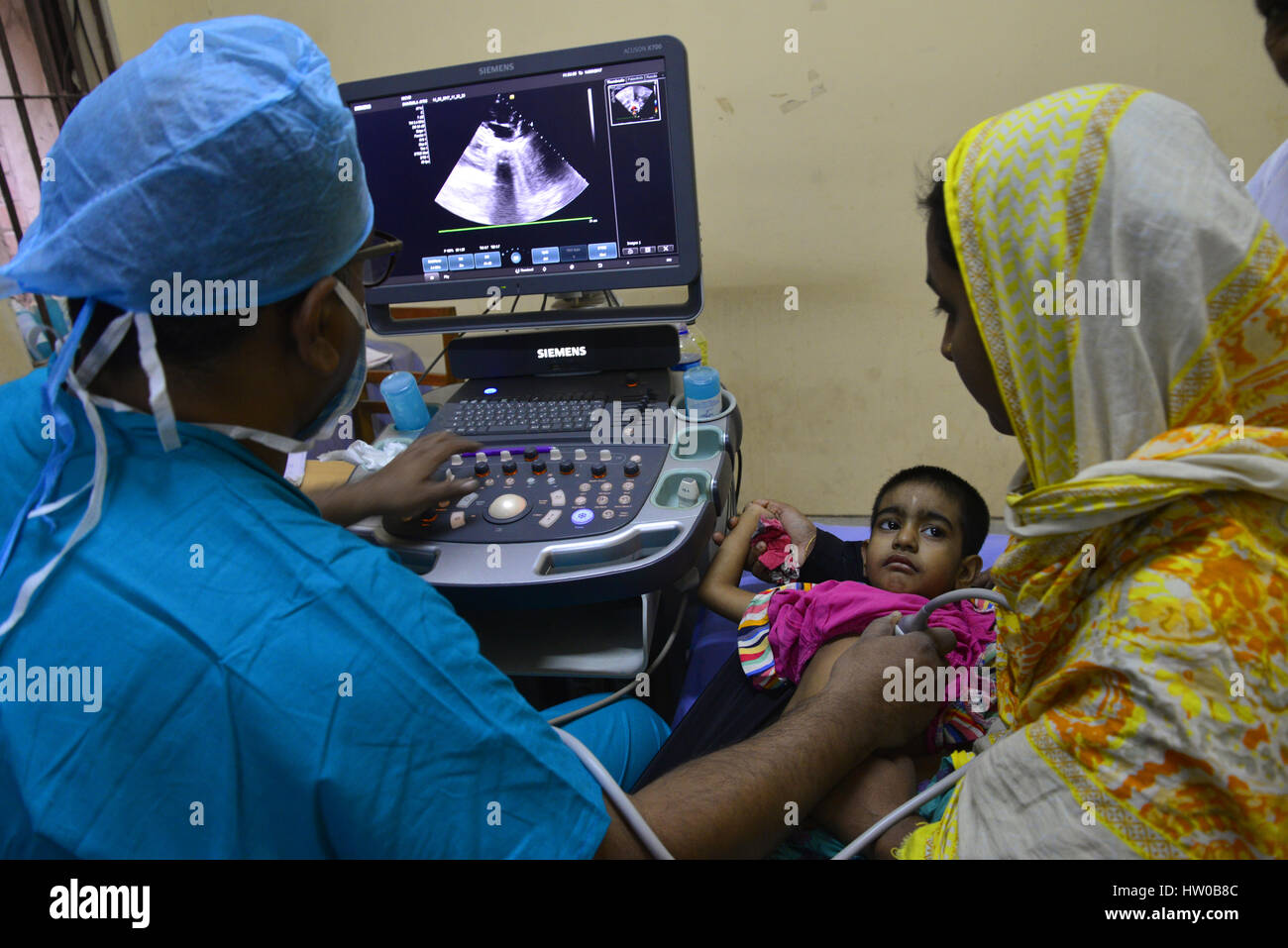 Bangladeshi Cardiologist gives echocardiography test to a child patient ...