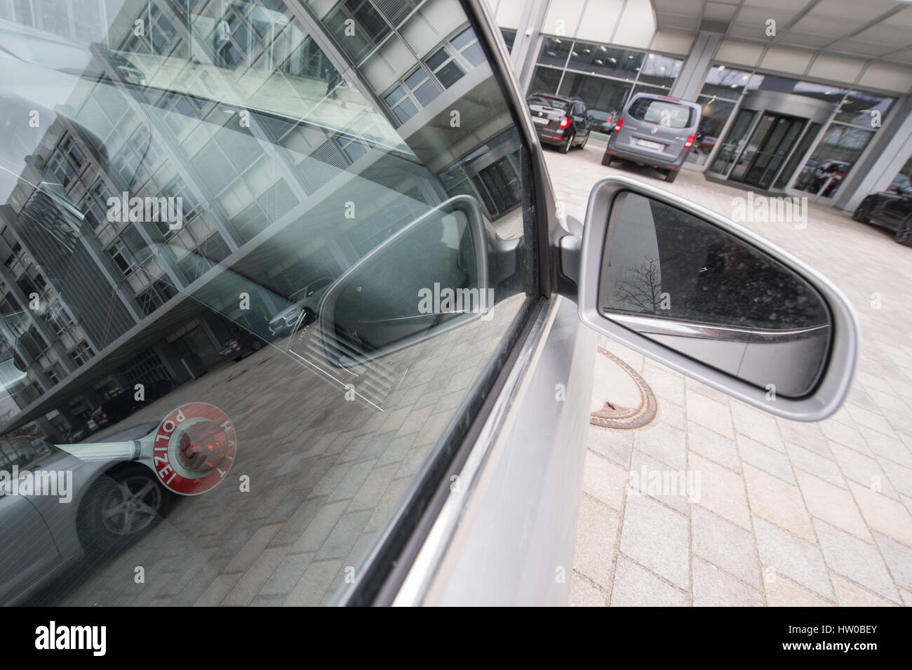 A police sign reflected in a car window of an undercover police car in ...