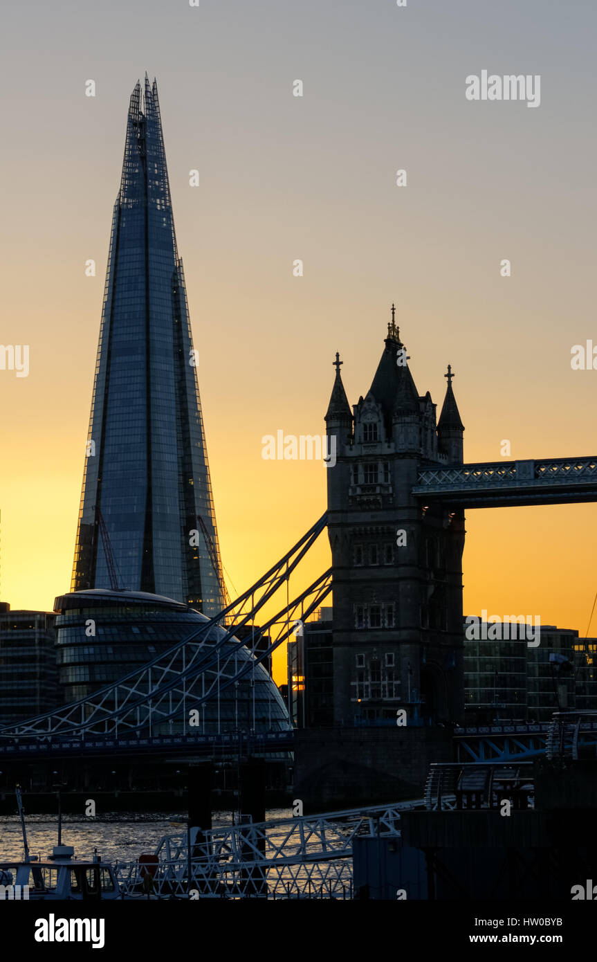 Silhouette of the Tower Bridge and the Shard at sunset, London, England ...