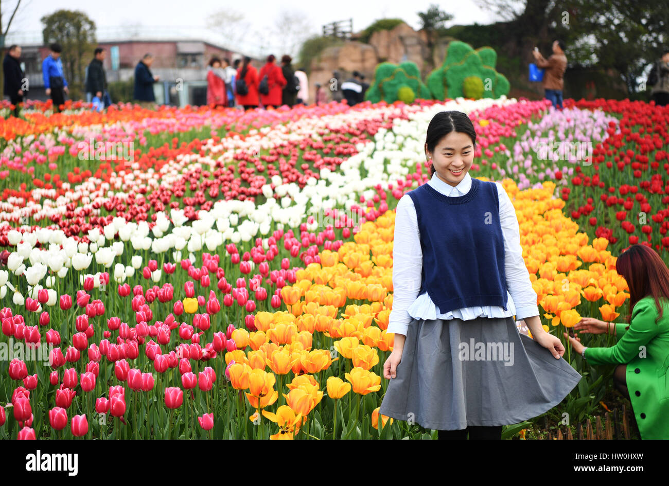 Changshou, China. 16th Mar, 2017. A woman poses for a photo in front of ...
