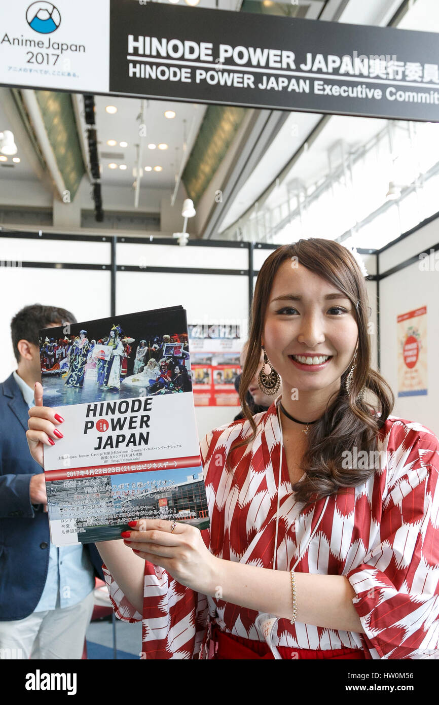 Tokyo, Japan. 23rd Mar, 2017. A booth assistant poses for a photograph ...