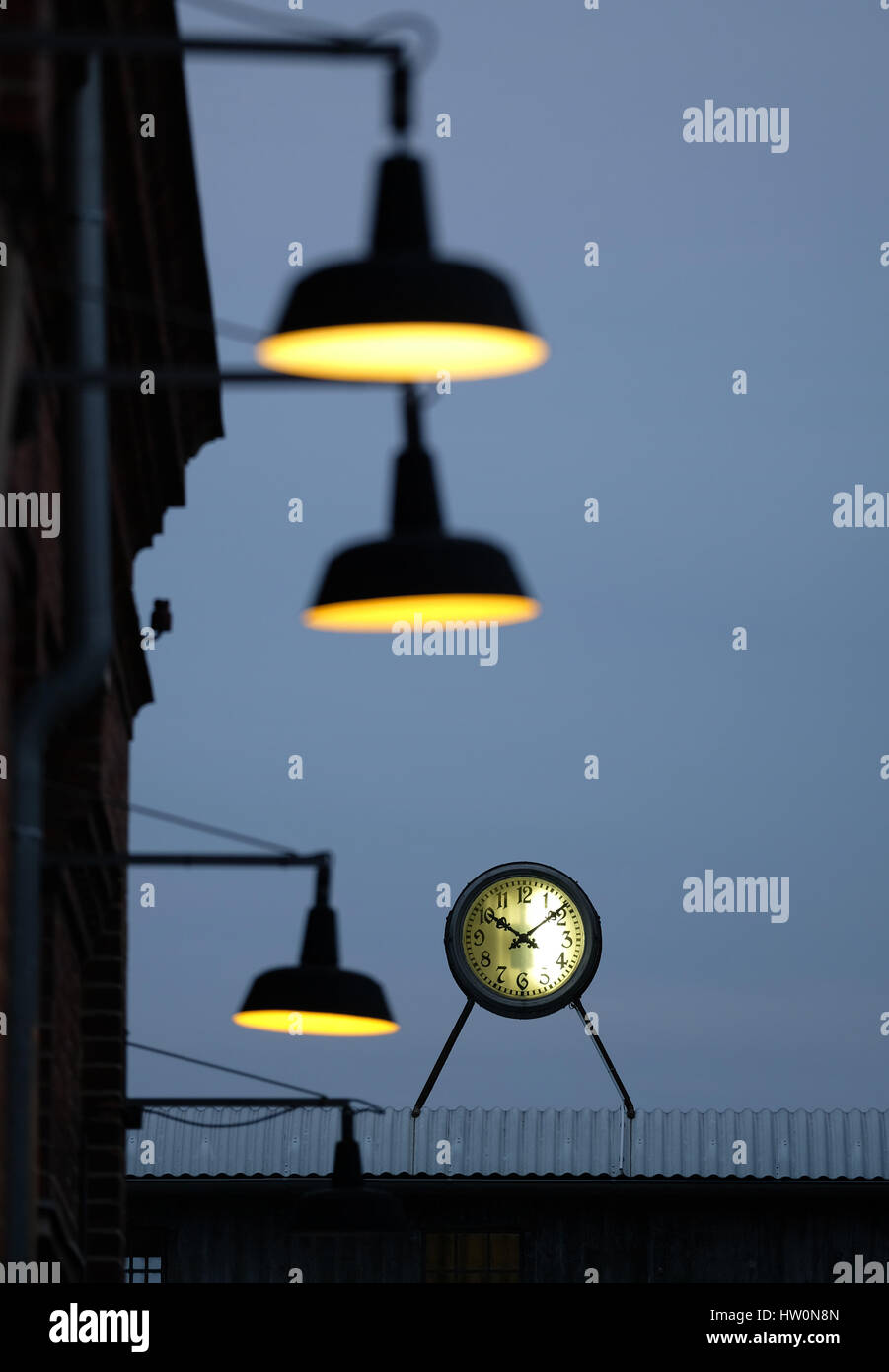 Leipzig, Germany. 22nd Mar, 2017. The dial of an old clock glows on the ...