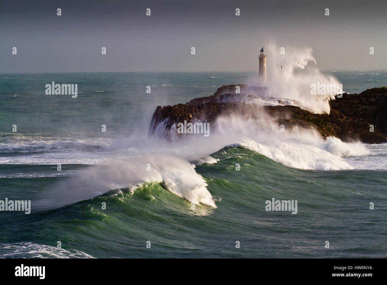 Mouro island and lighthouse in a storm. Santander. Cantabria, Spain ...
