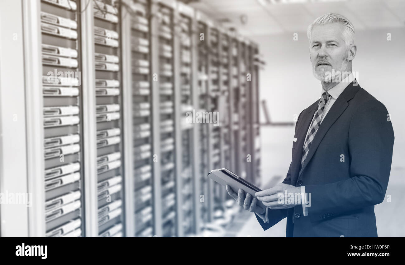 Portrait of senior businessman in big rack server room Stock Photo - Alamy