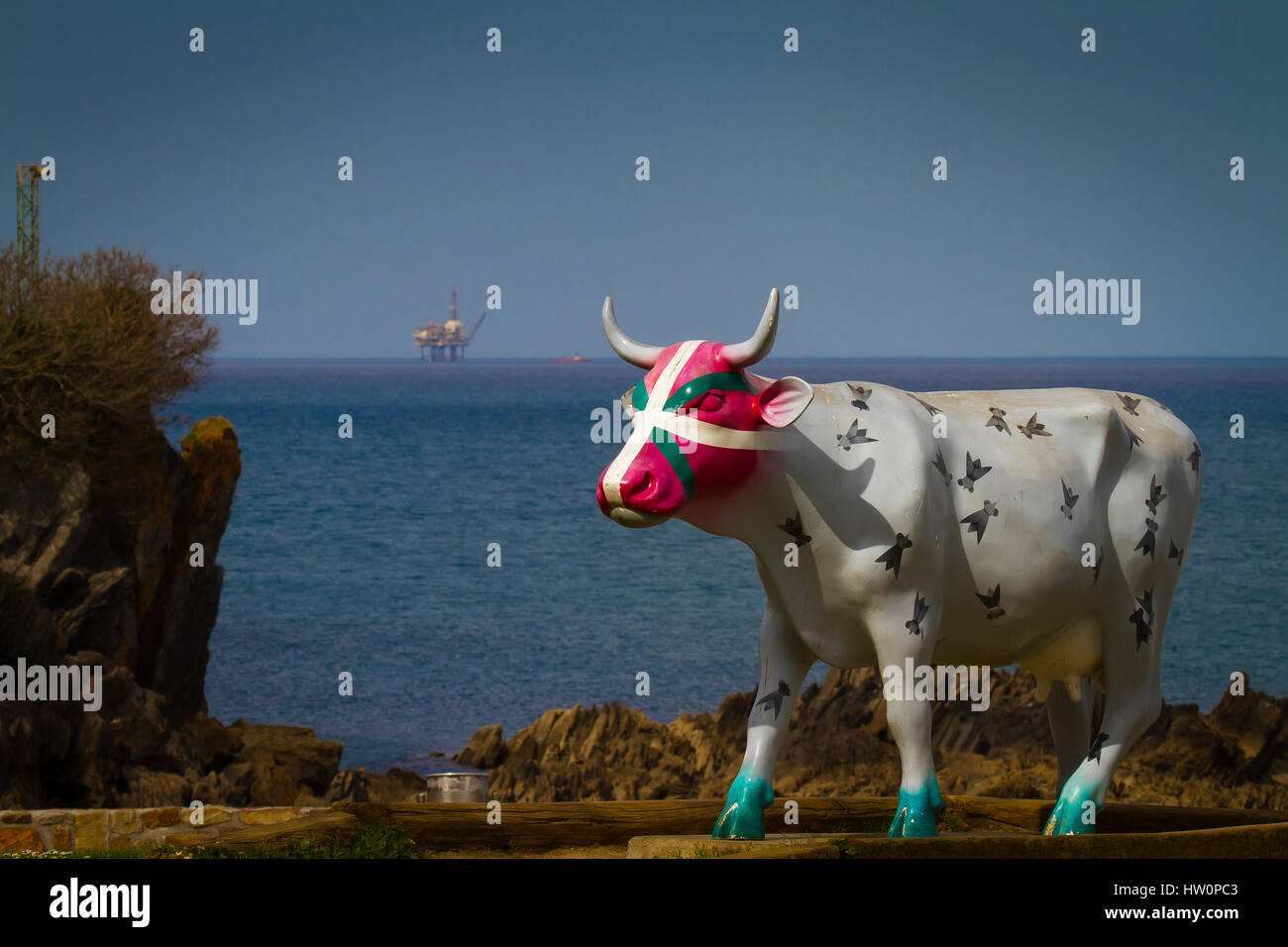 Painted cow and oil rig Stock Photo - Alamy