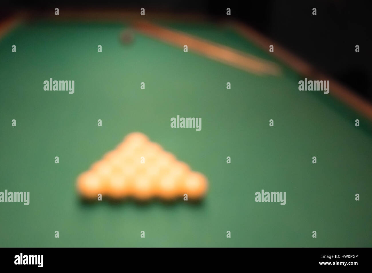Abstract blur. Billiard table with balls and cues in the light of lamps ...