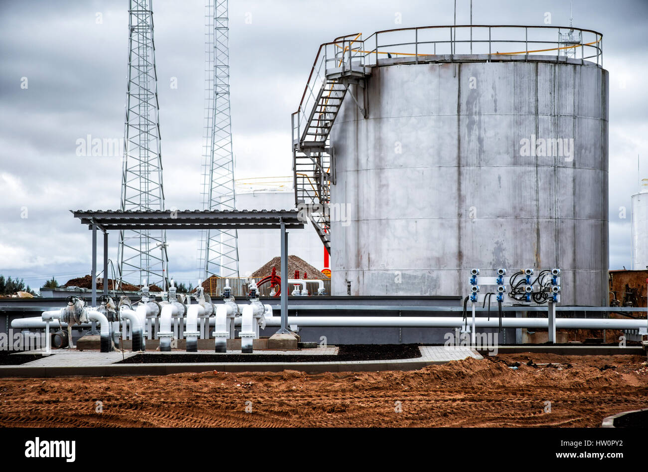 Large oil tank in industrial plant at twilight Stock Photo - Alamy