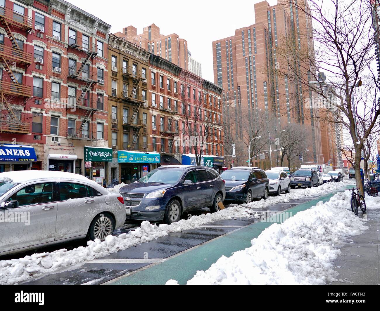 NYC street scene day after Storm Stella. Parked cars amid slush and ...