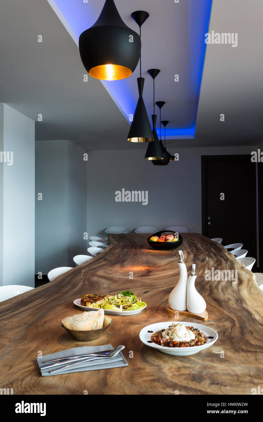 Large wooden contemporary dining table with food Stock Photo - Alamy