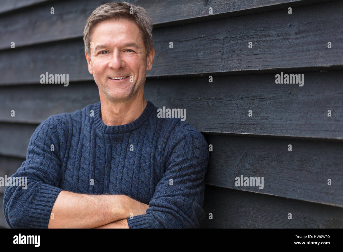 Portrait shot of an attractive, successful and happy middle aged man ...