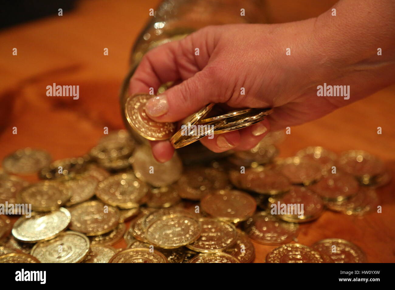 Senior female hand taking coin jar Stock Photo - Alamy