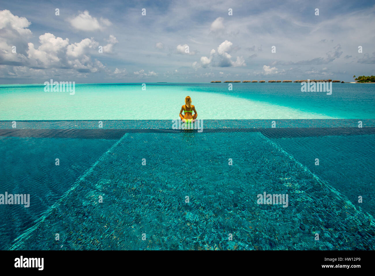 Maldives, Rangali Island. Conrad Hilton Resort. Woman in infinity pool ...