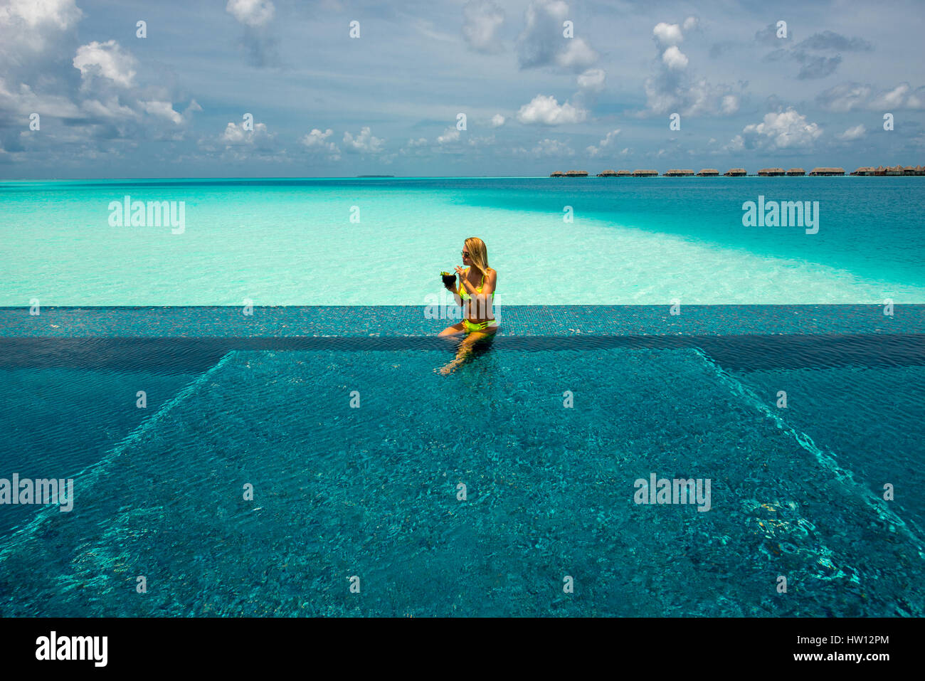 Maldives, Rangali Island. Conrad Hilton Resort. Woman in infinity pool ...