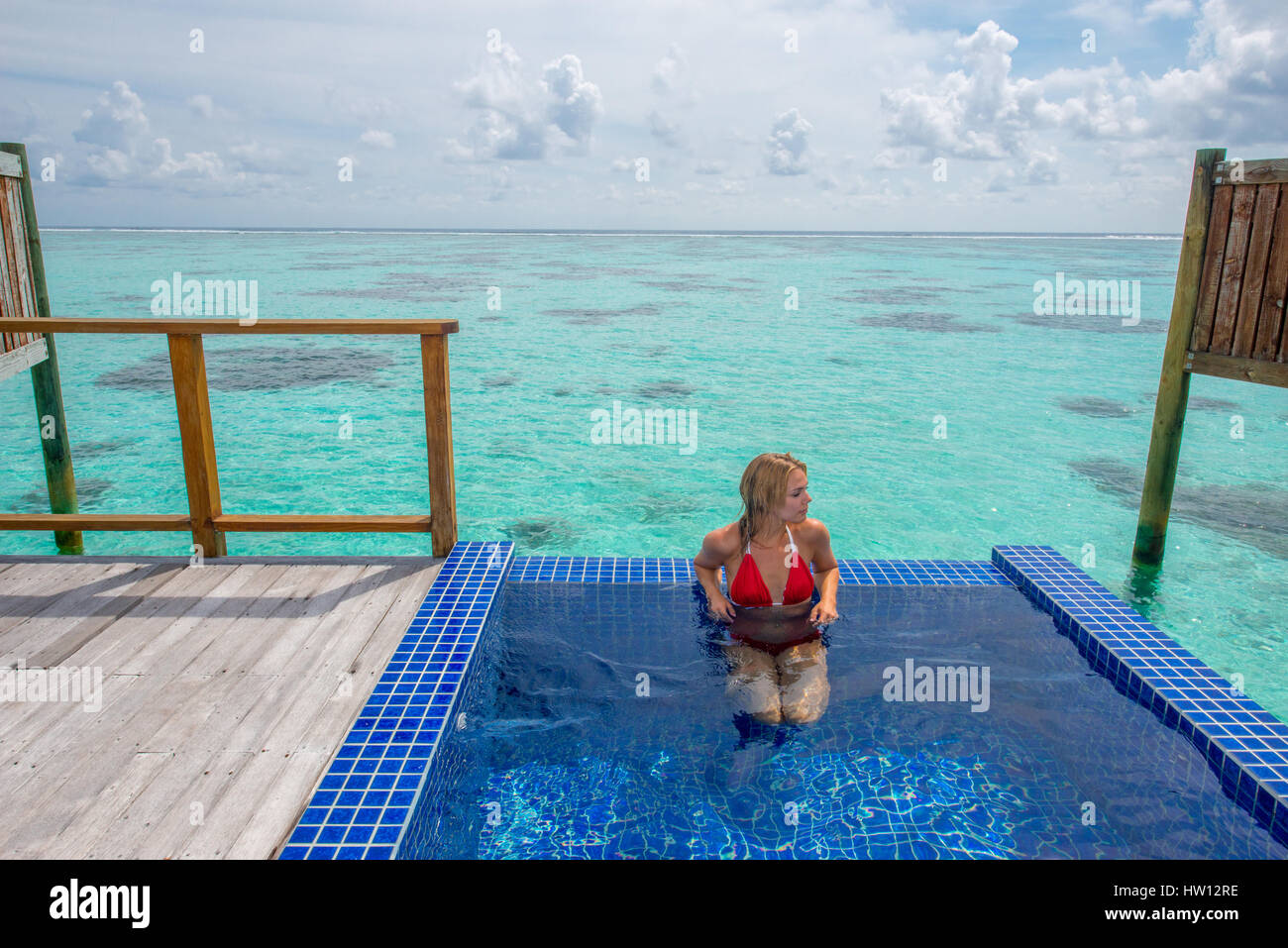 Maldives, Rangali Island. Conrad Hilton Resort. Woman in ocean villa ...