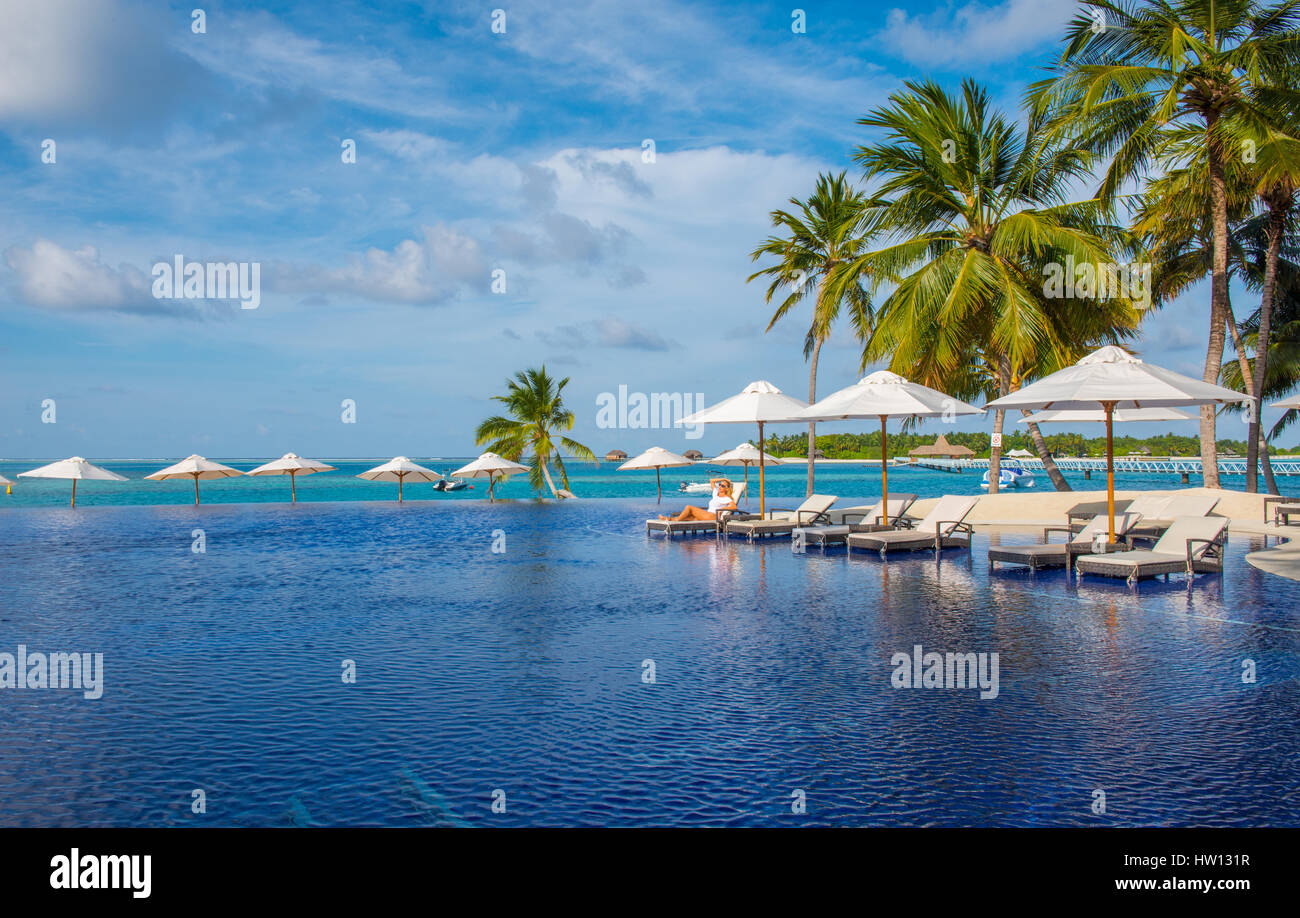 Maldives, Rangali Island. Conrad Hilton Resort. Woman relaxing at the ...