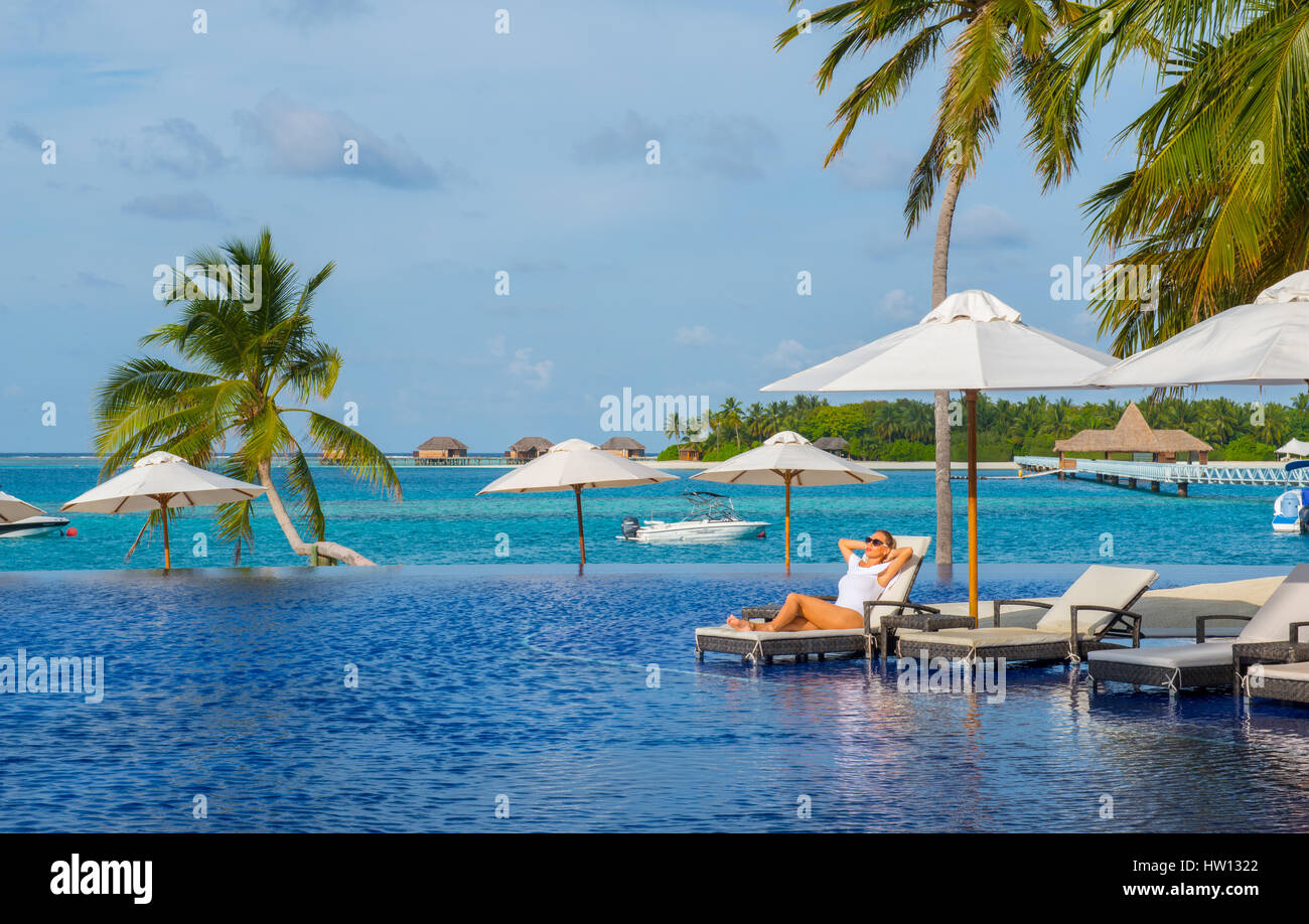 Maldives, Rangali Island. Conrad Hilton Resort. Woman relaxing at the ...