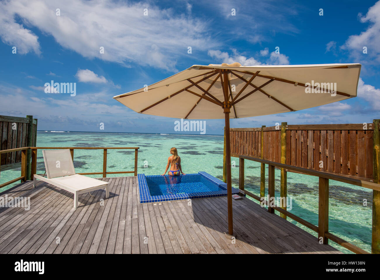 Maldives, Rangali Island. Conrad Hilton Resort. Woman in pool with view ...