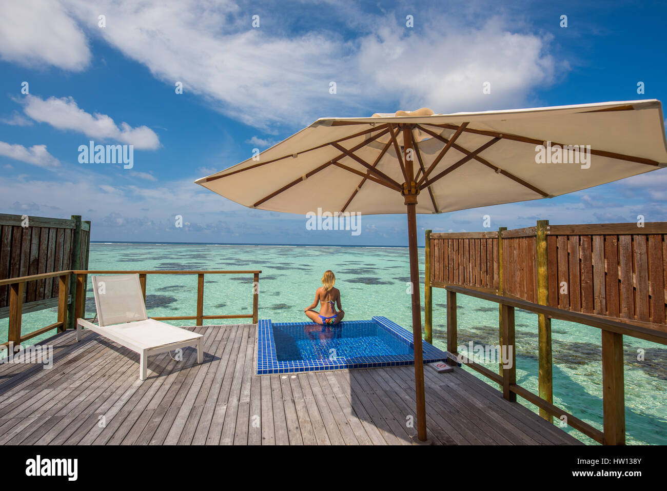 Maldives, Rangali Island. Conrad Hilton Resort. Woman in pool with view ...