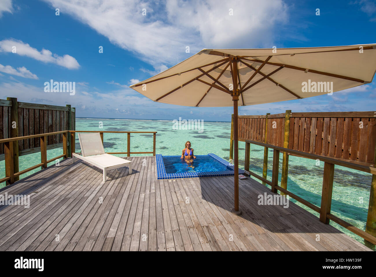 Maldives, Rangali Island. Conrad Hilton Resort. Woman in pool with view ...