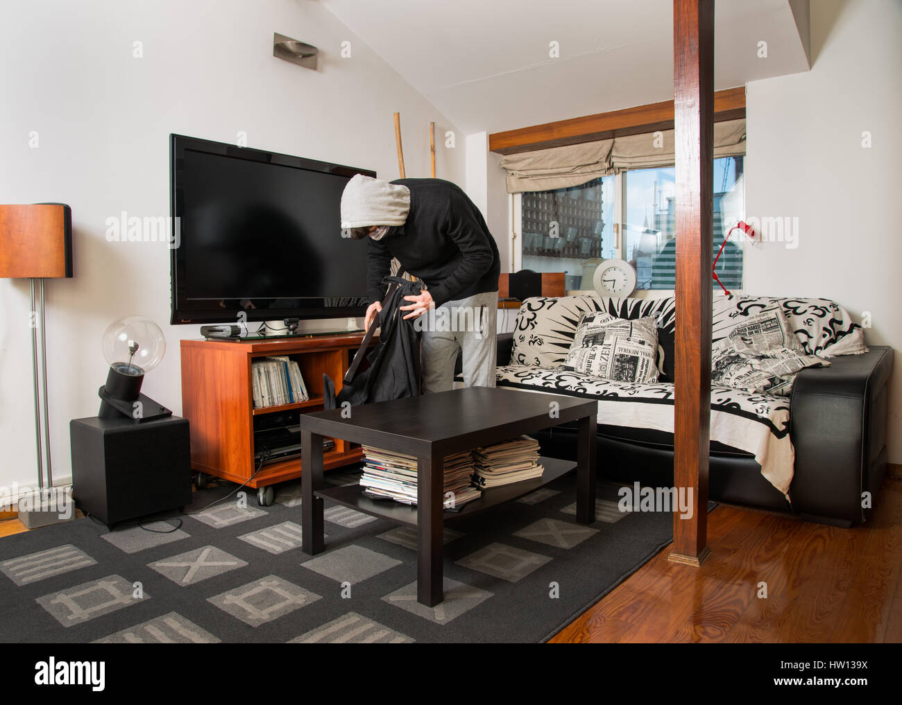 burglar robbing a house. Burglar stealing stuff in a living room Stock ...