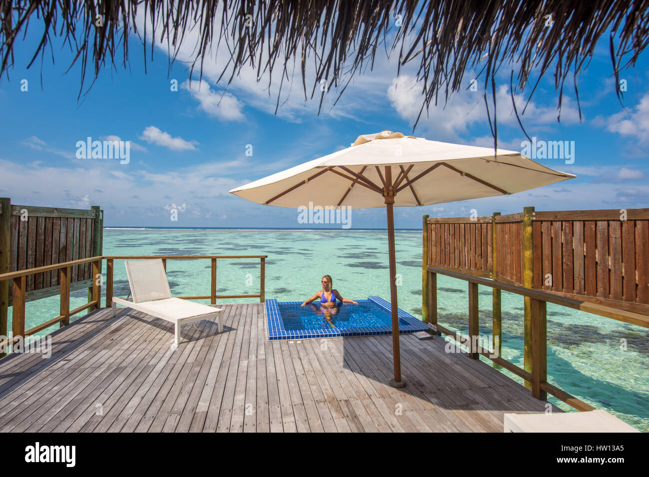 Maldives, Rangali Island. Conrad Hilton Resort. Woman in pool with view ...