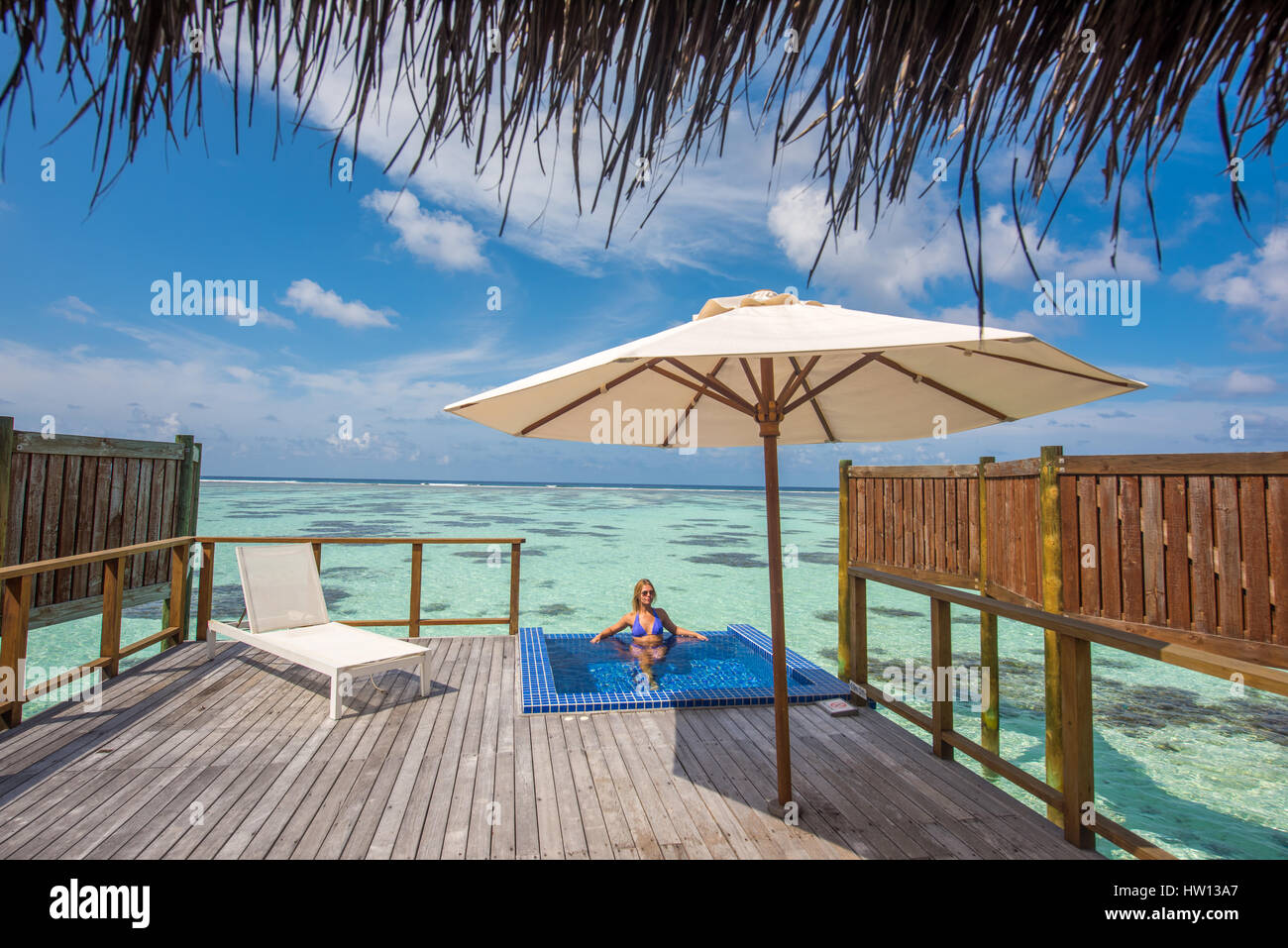 Maldives, Rangali Island. Conrad Hilton Resort. Woman in pool with view ...
