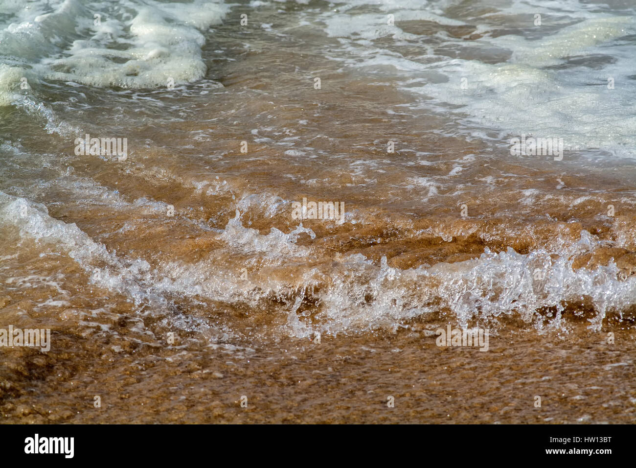 water breaking on sand background Stock Photo - Alamy