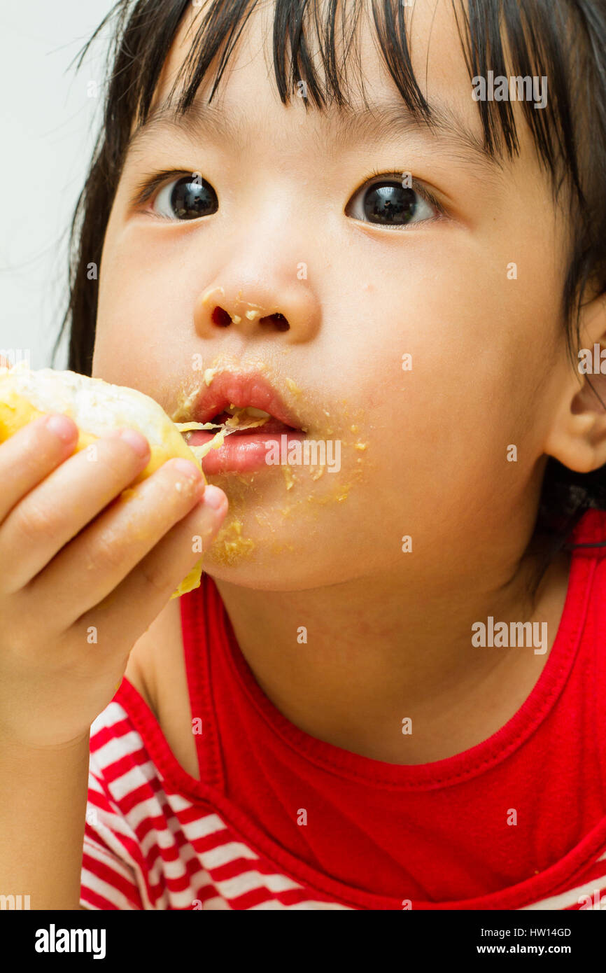 Asian Chinese little girl eating durian fruit Stock Photo - Alamy